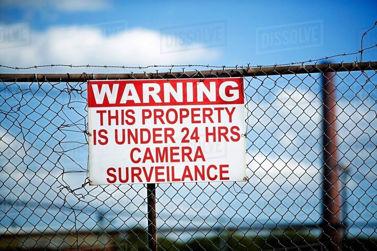 Warning sign on fence - Stock Photo - Dissolve