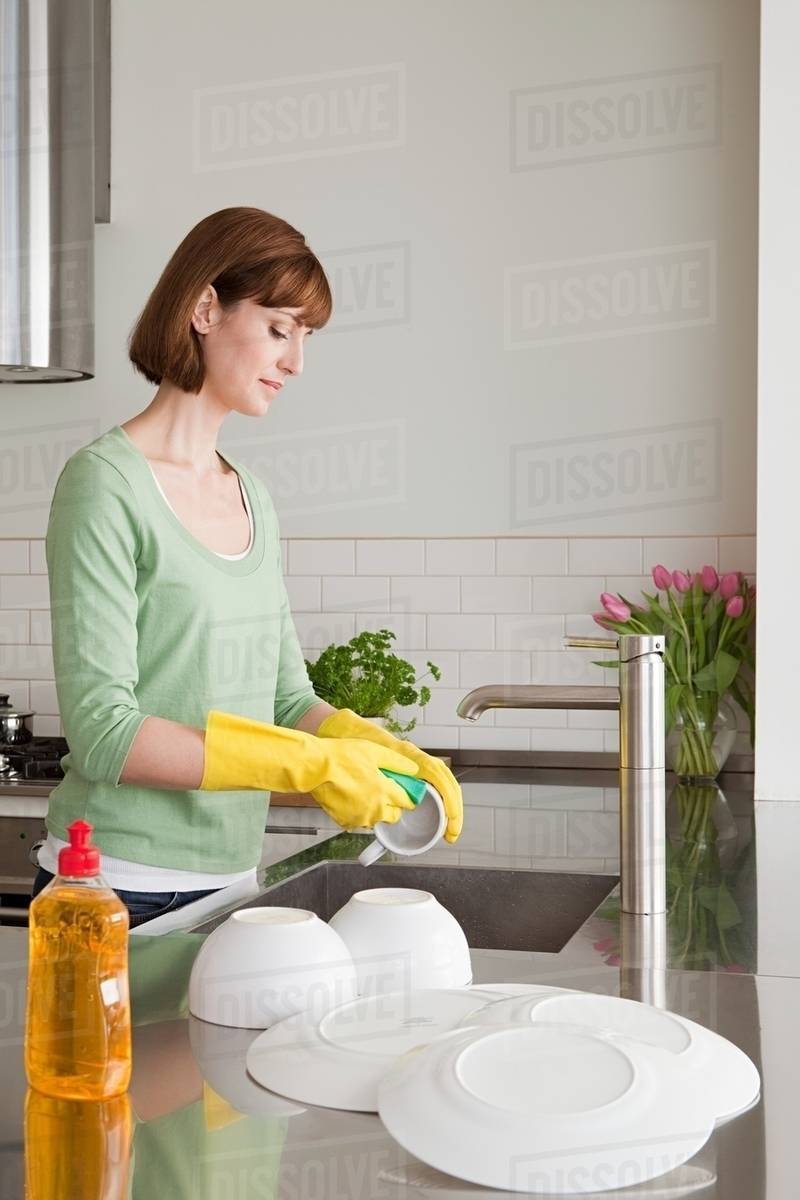 Woman washing up - Royalty-free Stock Photo | Dissolve