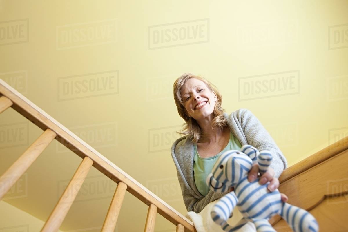 Woman looking in to crib - Royalty-free Stock Photo | Dissolve