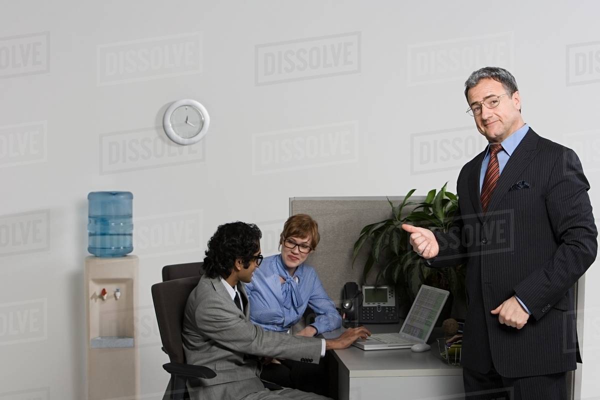 Boss pointing to businesspeople - Stock Photo - Dissolve