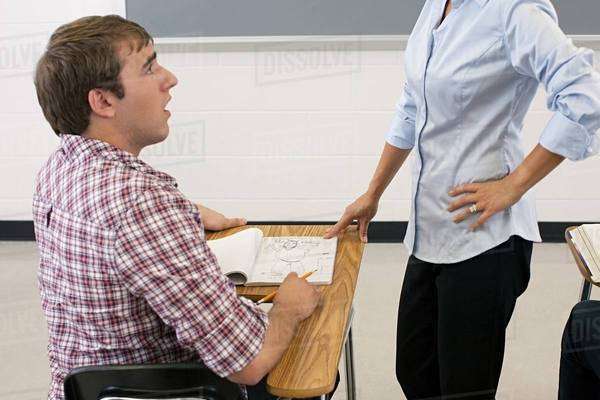 Male high school student being told off for doodling - Royalty-free ...