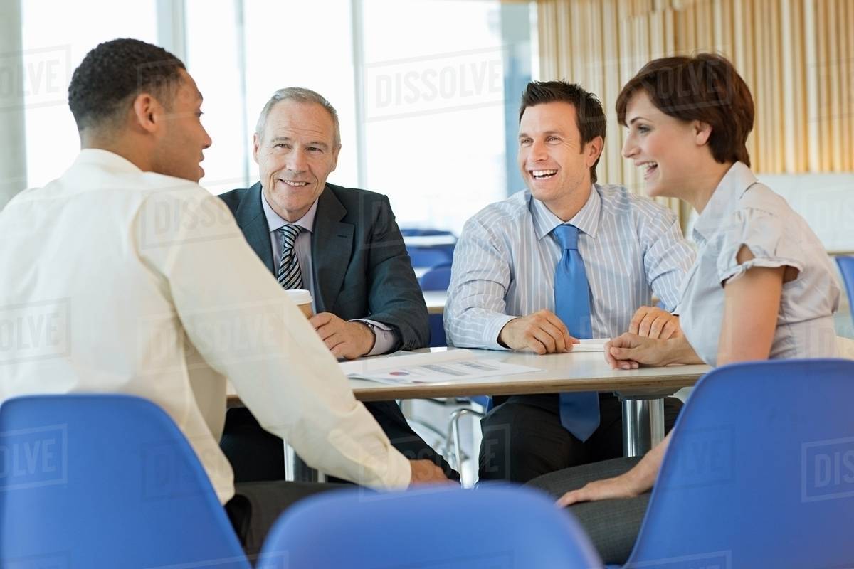 Smiling businesspeople in meeting - Stock Photo - Dissolve