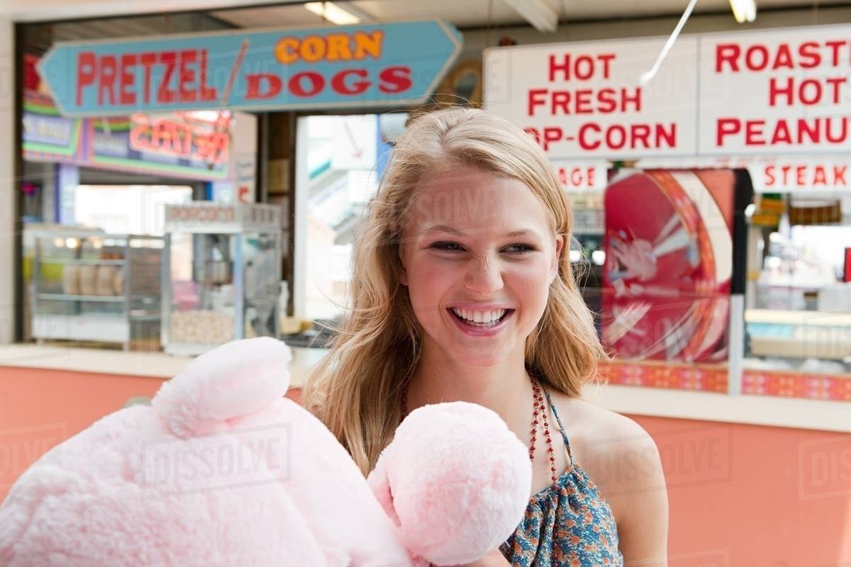 Teenage girl at fun fair with teddy bear - Royalty-free Stock Photo ...