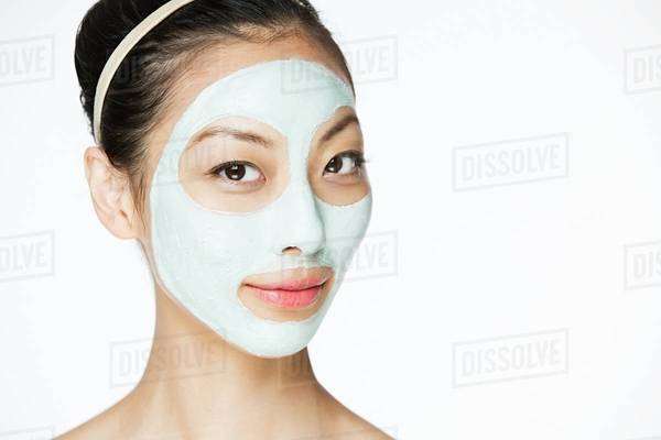 Young woman wearing face mask - Stock Photo - Dissolve