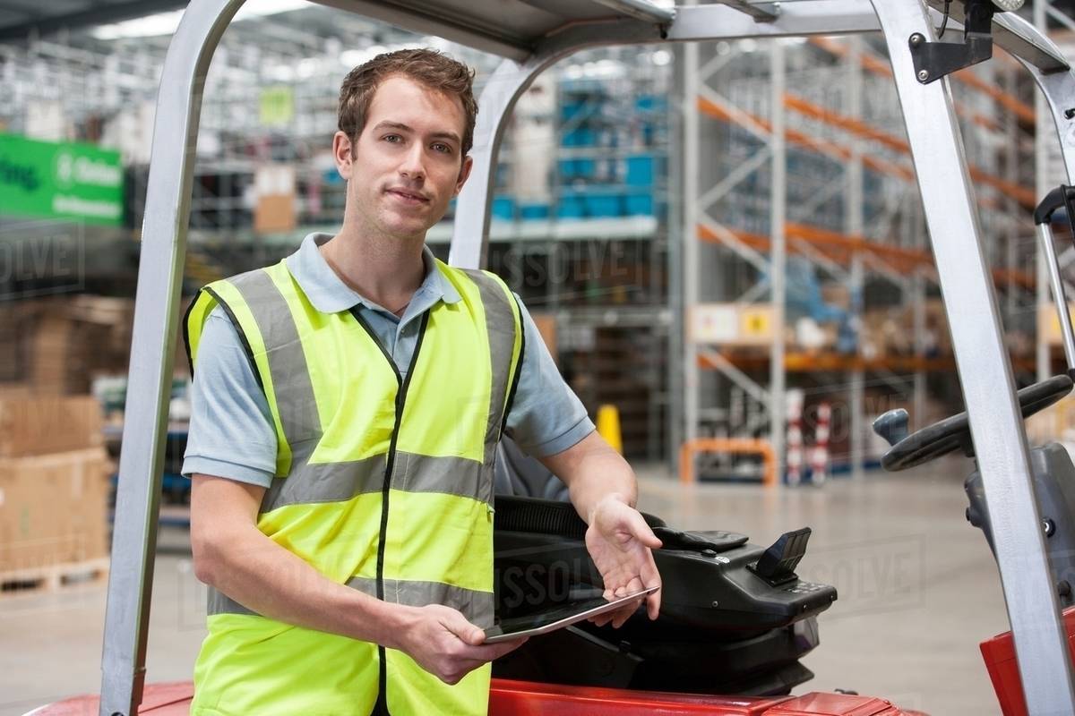 Man sitting with forklift truck, portrait - Royalty-free Stock Photo ...