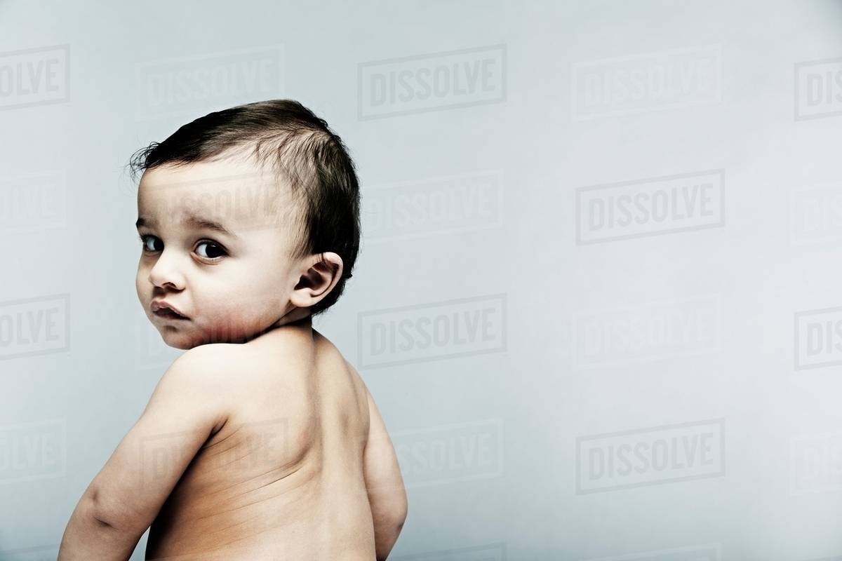 Portrait of baby boy looking over shoulder at camera - Royalty-free ...