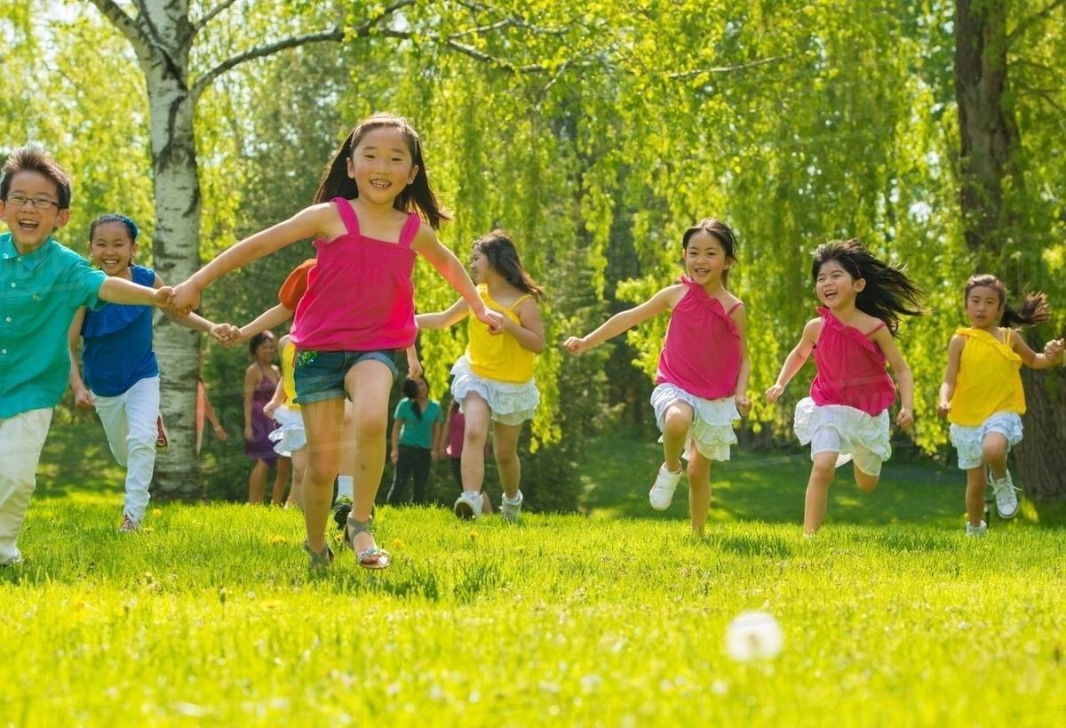 Children running on grass - Royalty-free Stock Photo | Dissolve