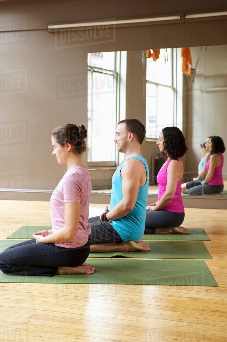 People kneeling in yoga class - Royalty-free Stock Photo | Dissolve