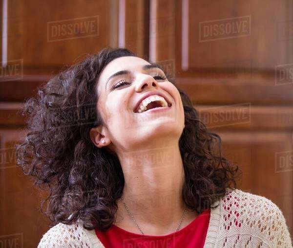 Young woman with head back laughing - Royalty-free Stock Photo | Dissolve