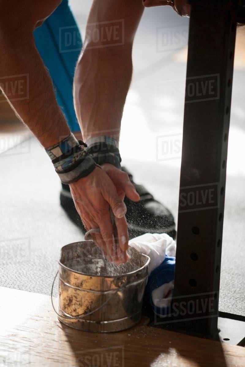 Man puts powder on hands before workout - Royalty-free Stock Photo ...