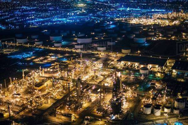 Aerial view of oil refinery illuminated at night, Los Angeles ...