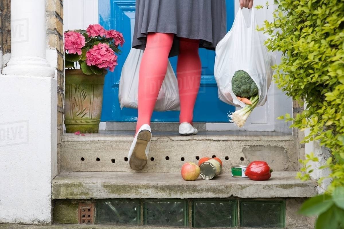 Shopping falling from a torn bag - Stock Photo - Dissolve