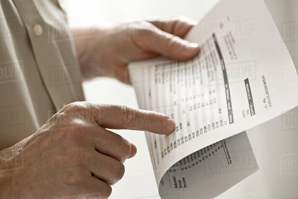 A man holding a bank statement - Stock Photo - Dissolve