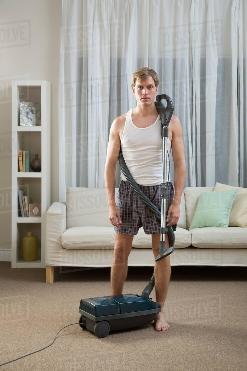 Portrait of a man with a vacuum cleaner - Stock Photo - Dissolve