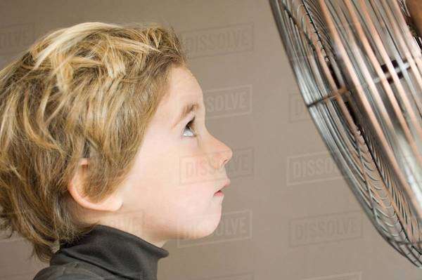 Boy looking at fan - Royalty-free Stock Photo | Dissolve
