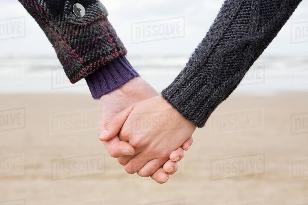 Holding hands - Stock Photo - Dissolve