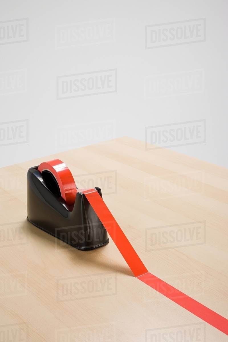 Red tape on desk - Stock Photo - Dissolve