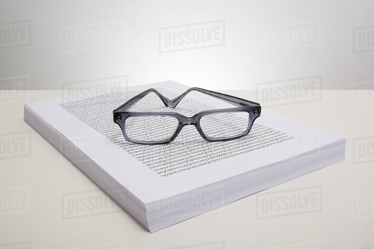 Eyeglasses and a stack of paper - Royalty-free Stock Photo | Dissolve