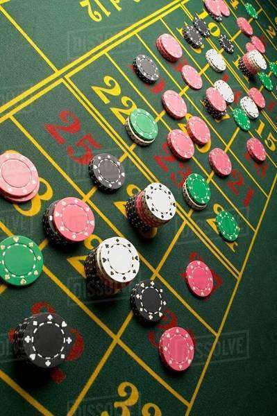 Gambling chips on a roulette table - Stock Photo - Dissolve