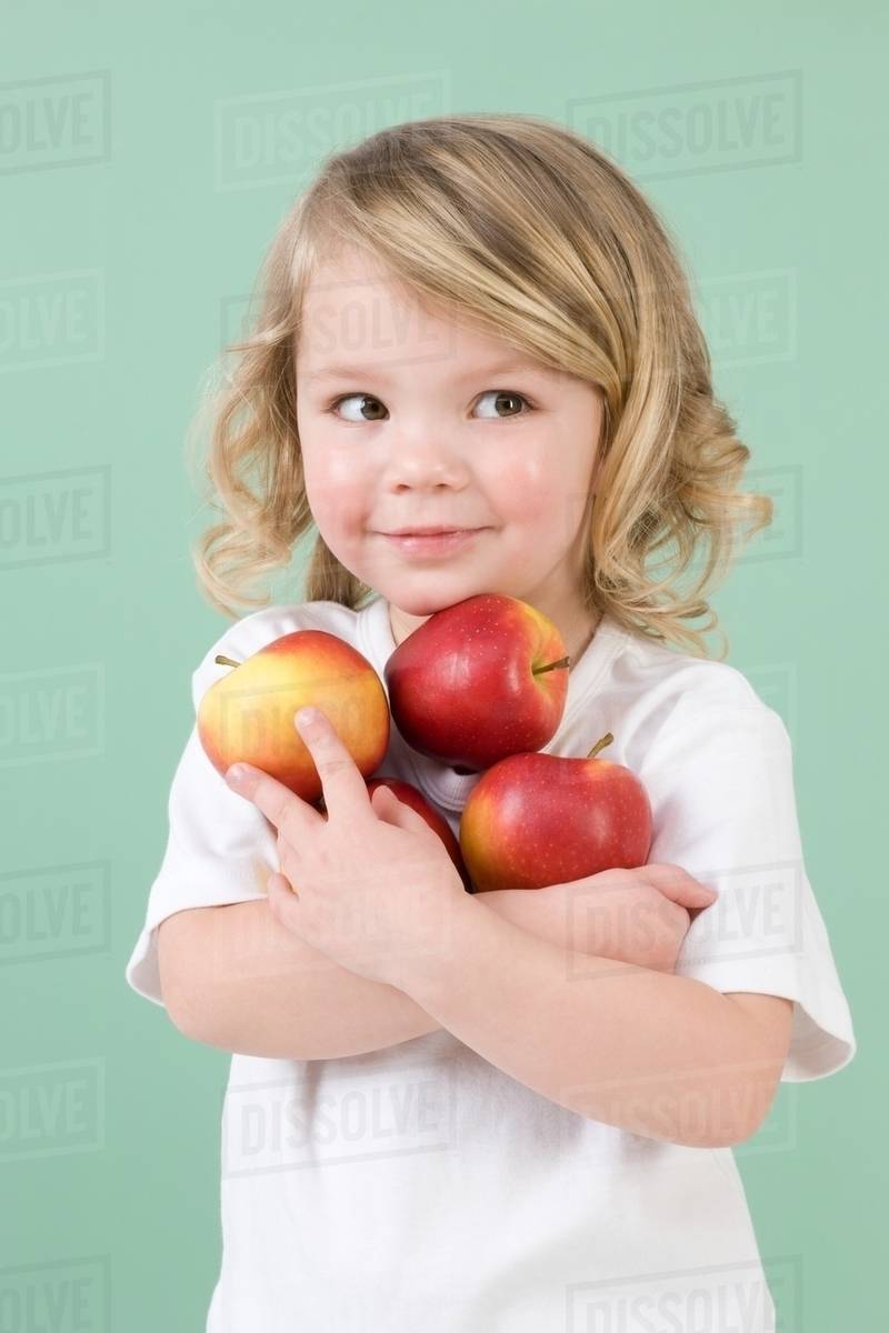 Girl holding apples - Royalty-free Stock Photo | Dissolve