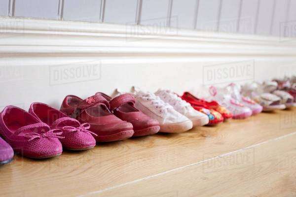Child's shoes in a row - Royalty-free Stock Photo | Dissolve