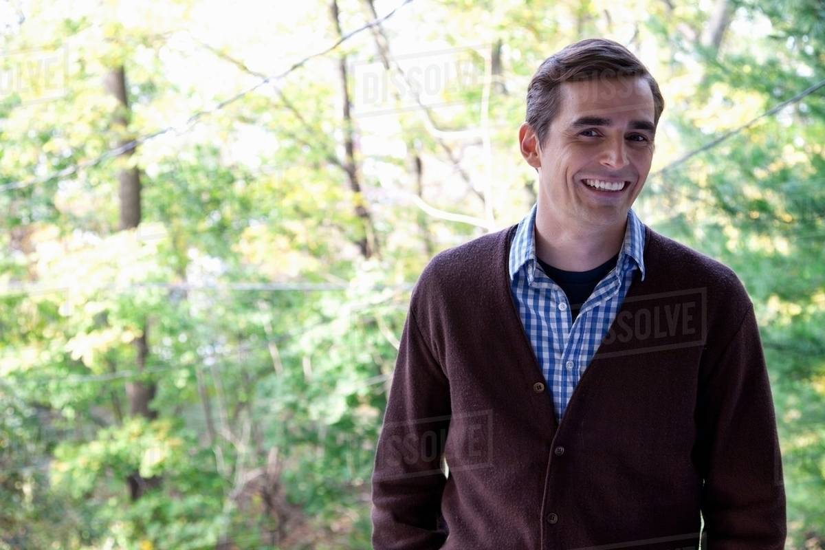 Smiling man standing outdoors - Stock Photo - Dissolve