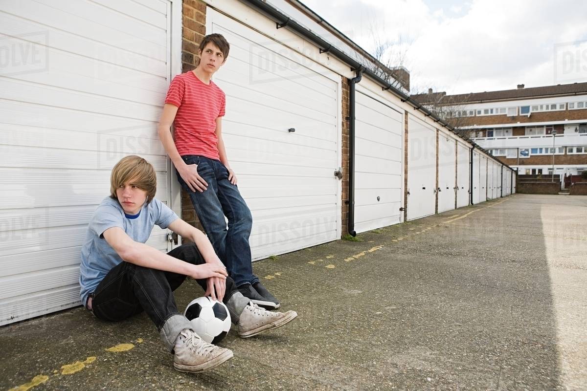 Teenage boys by garages - Royalty-free Stock Photo | Dissolve
