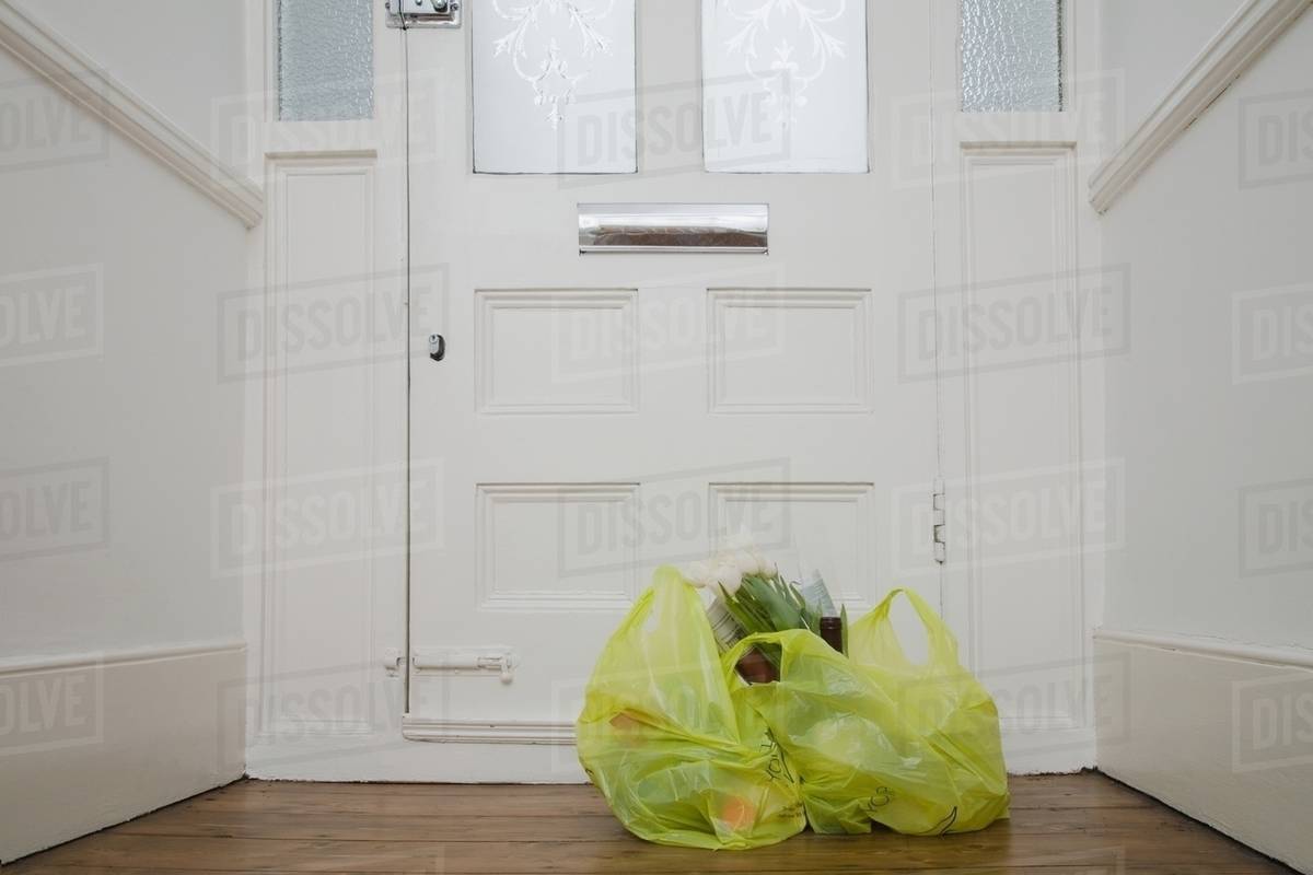 Shopping bags by front door - Royalty-free Stock Photo | Dissolve