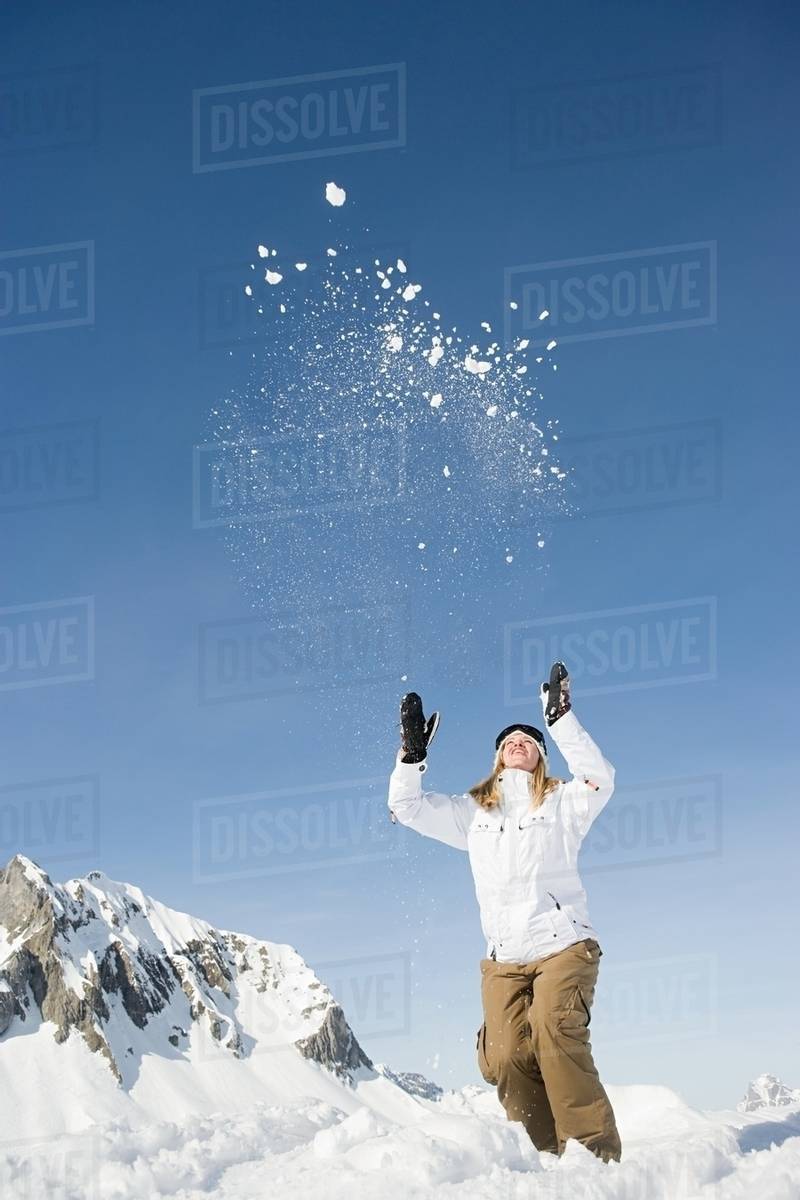 A woman throwing snow - Royalty-free Stock Photo | Dissolve