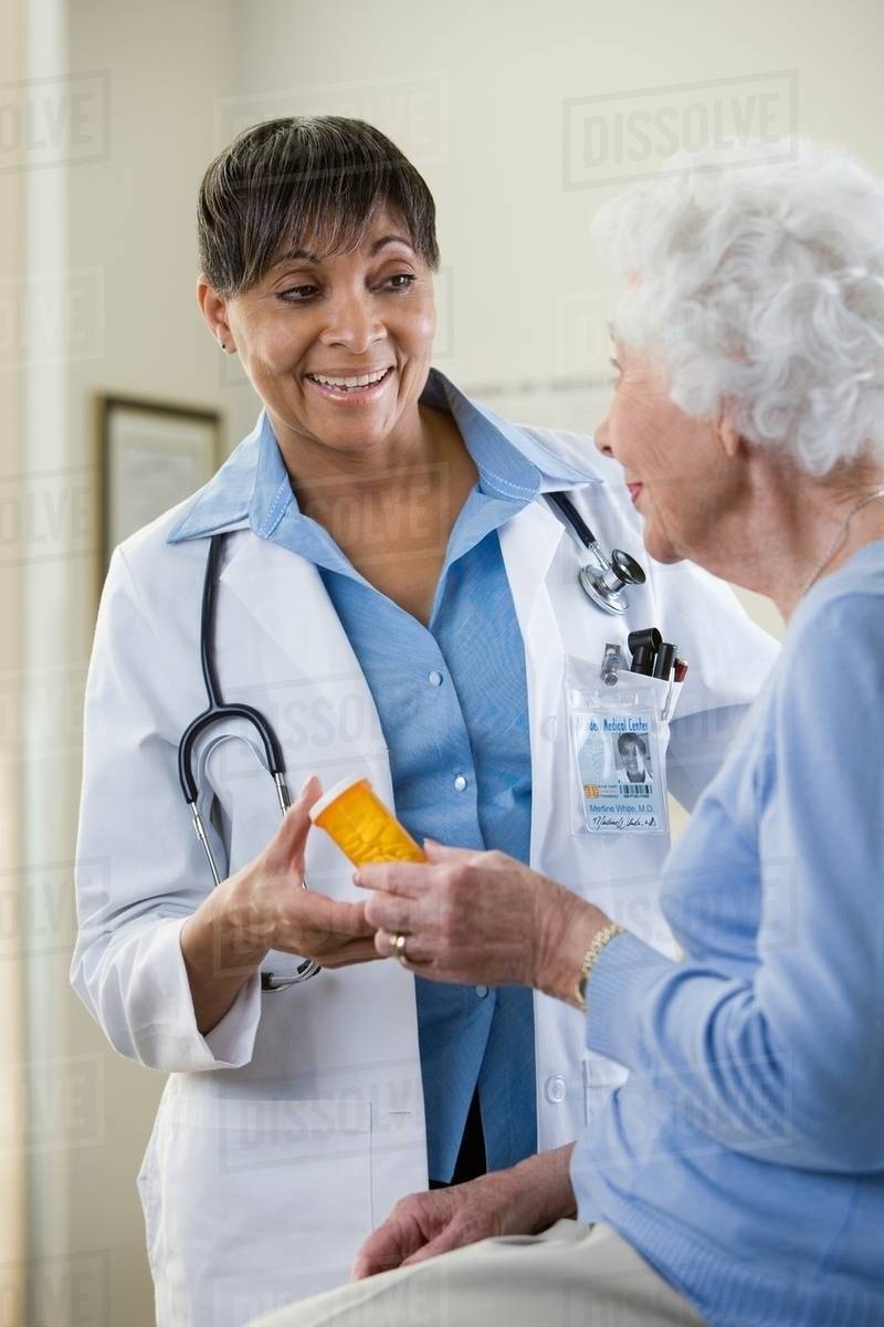 A doctor handing a patient tablets - Royalty-free Stock Photo | Dissolve