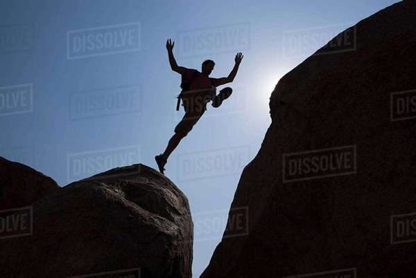 Man jumping chasm - Royalty-free Stock Photo | Dissolve