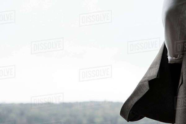A businessman holding a jacket - Stock Photo - Dissolve