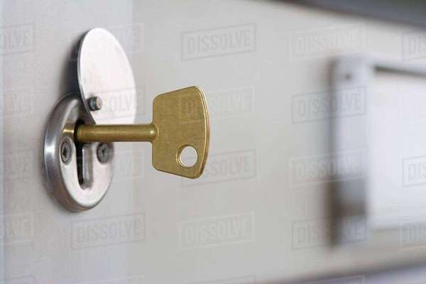 A key in a lock - Stock Photo - Dissolve
