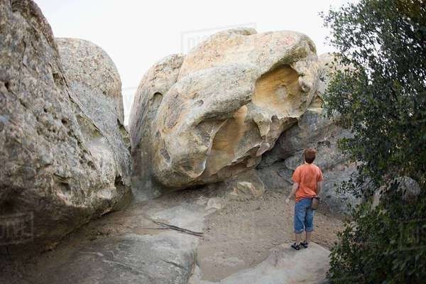Rock climber looking at rocks - Stock Photo - Dissolve