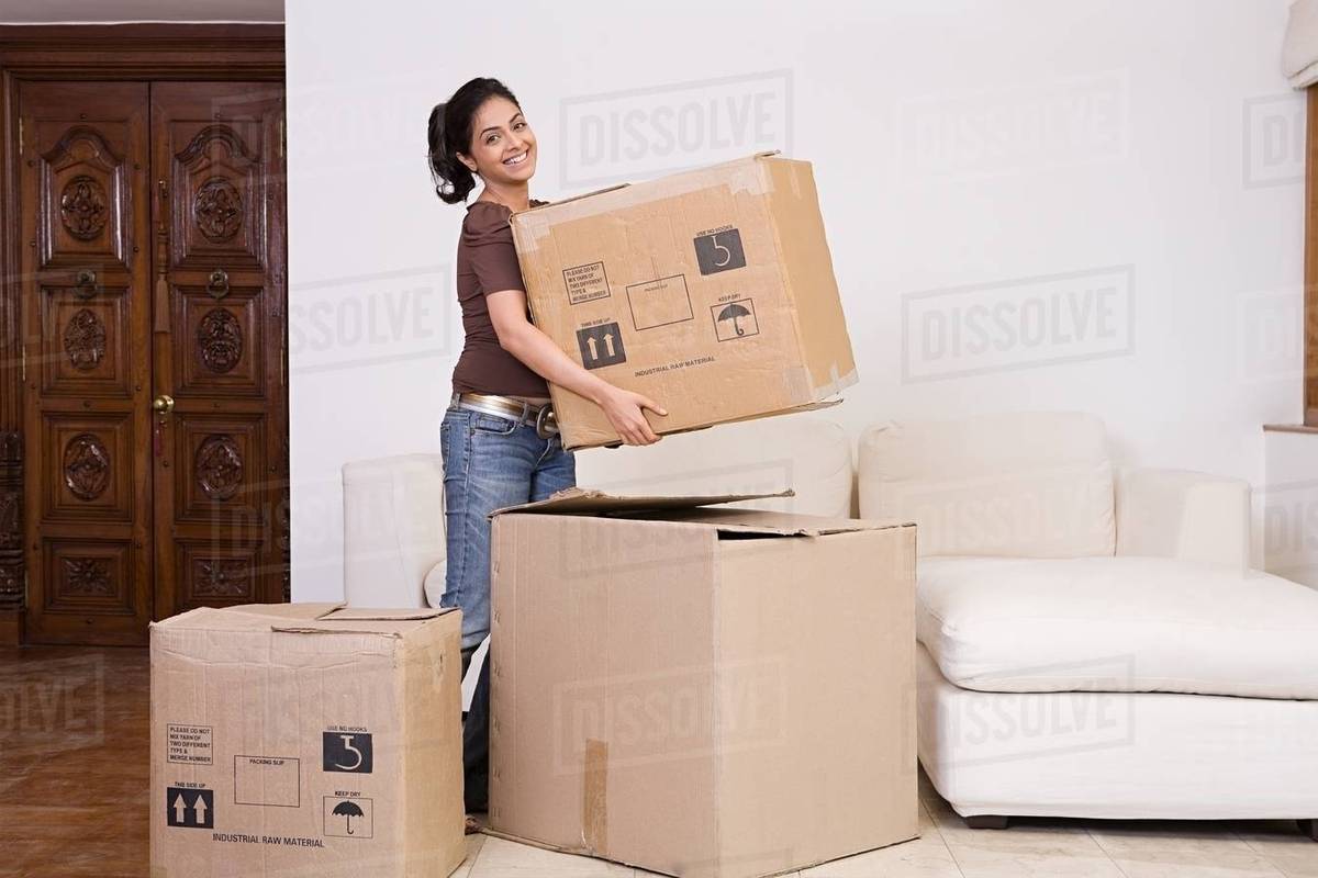 A woman lifting boxes - Royalty-free Stock Photo | Dissolve