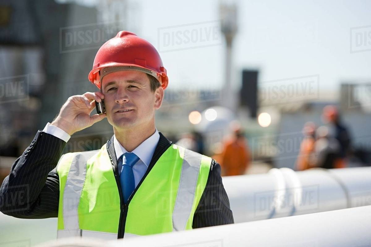 Engineer on cellphone - Stock Photo - Dissolve
