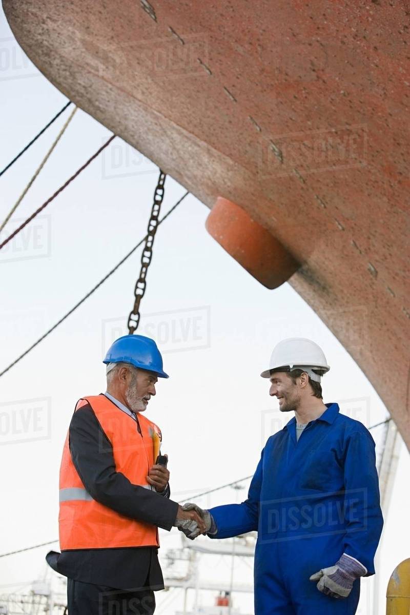 Workers shaking hands - Royalty-free Stock Photo | Dissolve