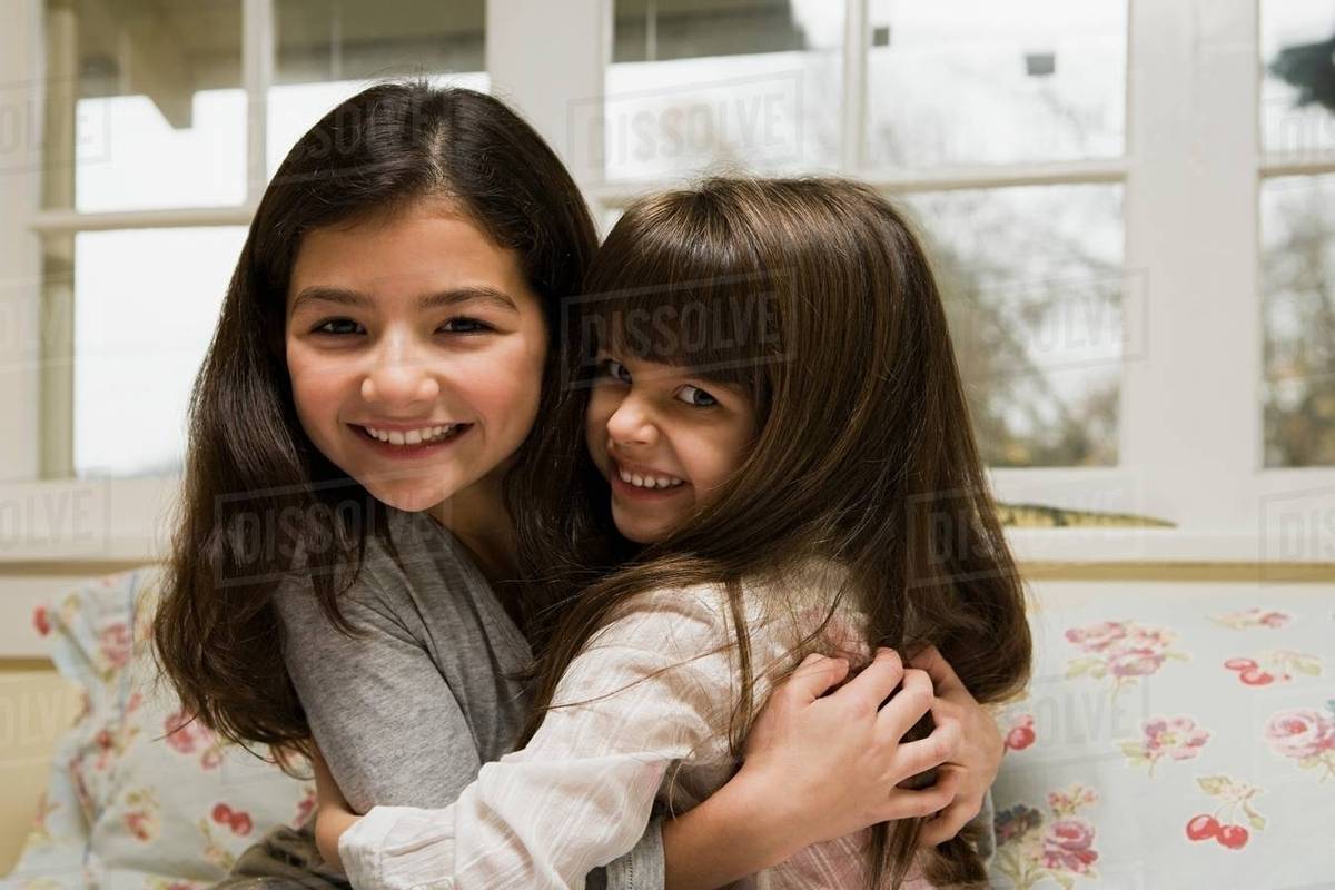 Sisters hugging - Stock Photo - Dissolve