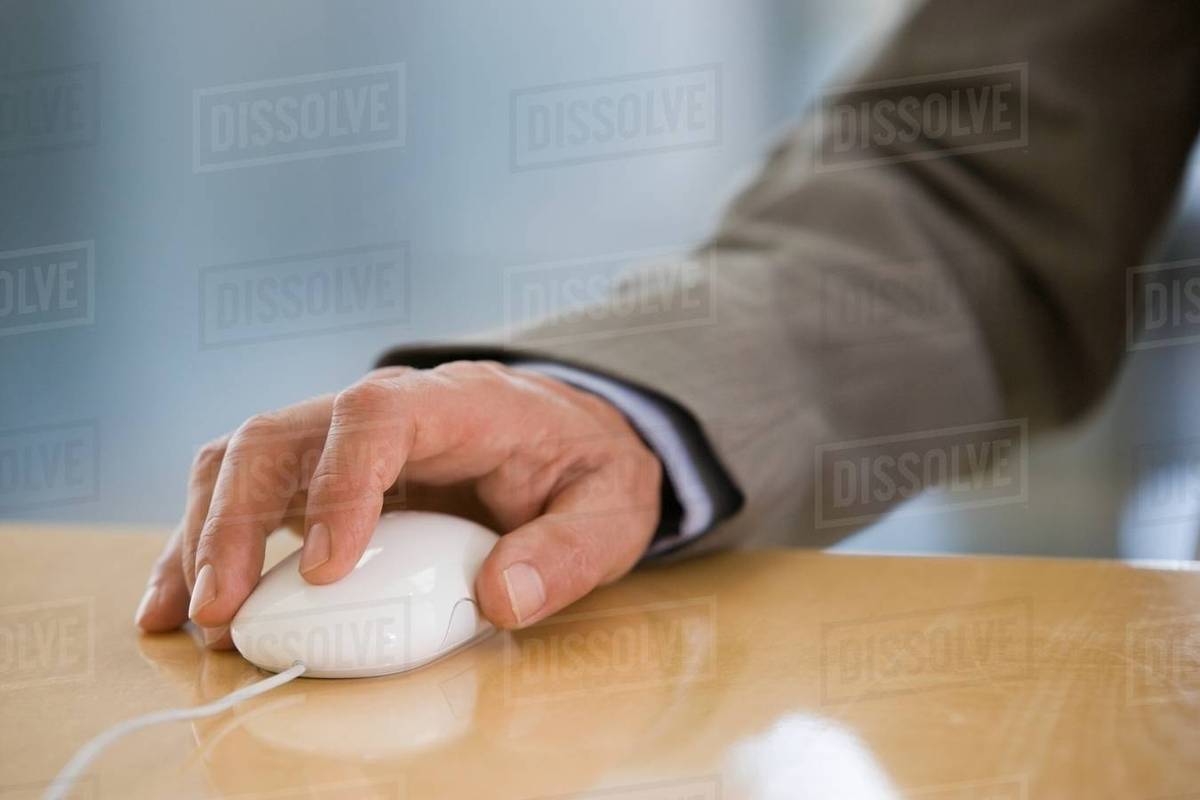 Businessman using a mouse - Royalty-free Stock Photo | Dissolve