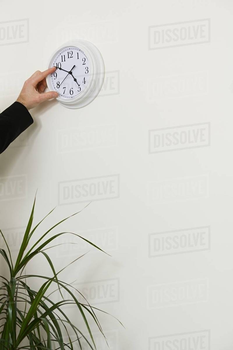 An office worker adjusting the hands on a clock - Royalty-free Stock ...