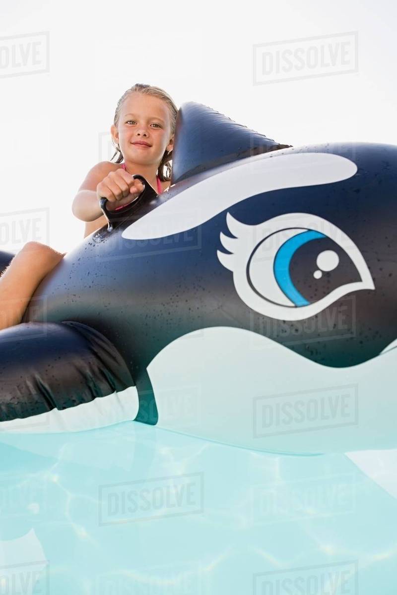 Girl on inflatable whale - Royalty-free Stock Photo | Dissolve
