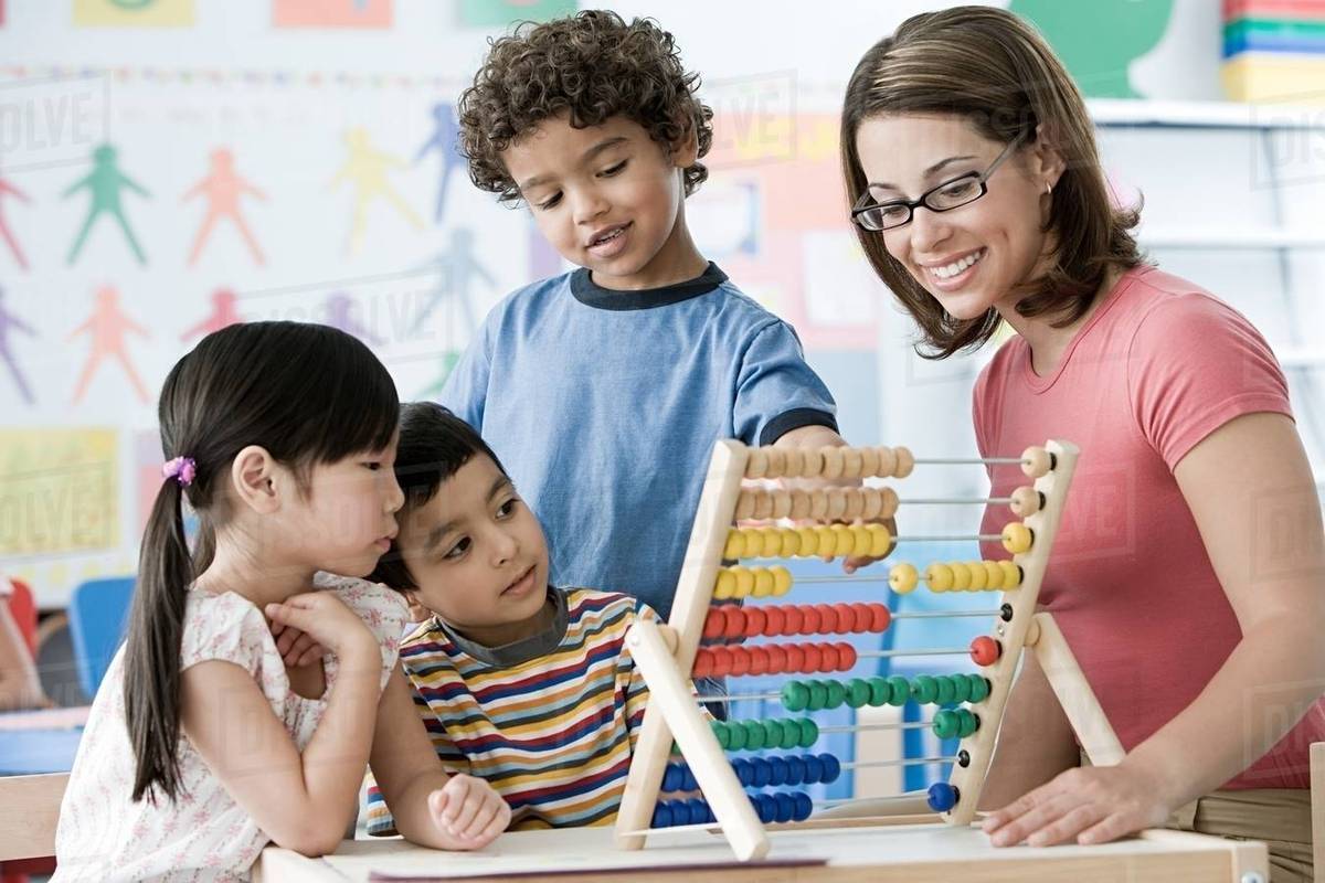 A teacher and children counting on an abacus - Royalty-free Stock Photo ...