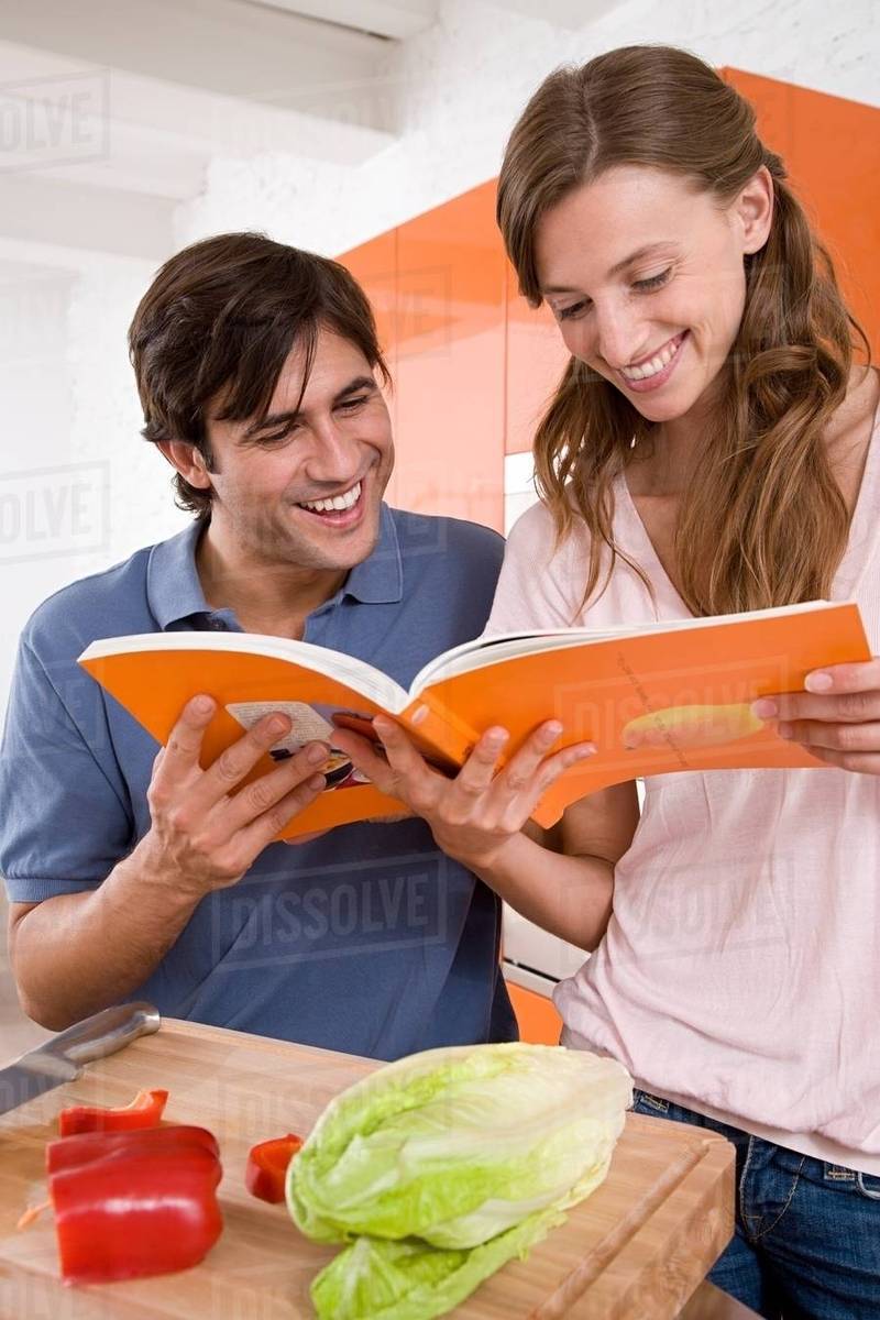 A couple reading a cookbook - Royalty-free Stock Photo | Dissolve