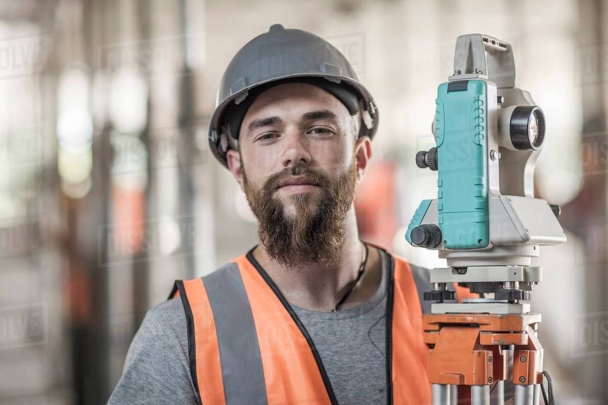 Portrait of young male surveyor on construction site - Stock Photo ...