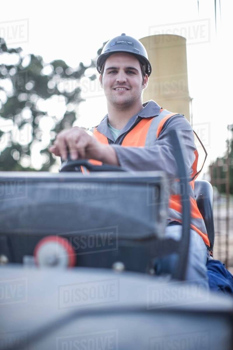 Portrait of young male steamroller driver on construction site - Stock ...