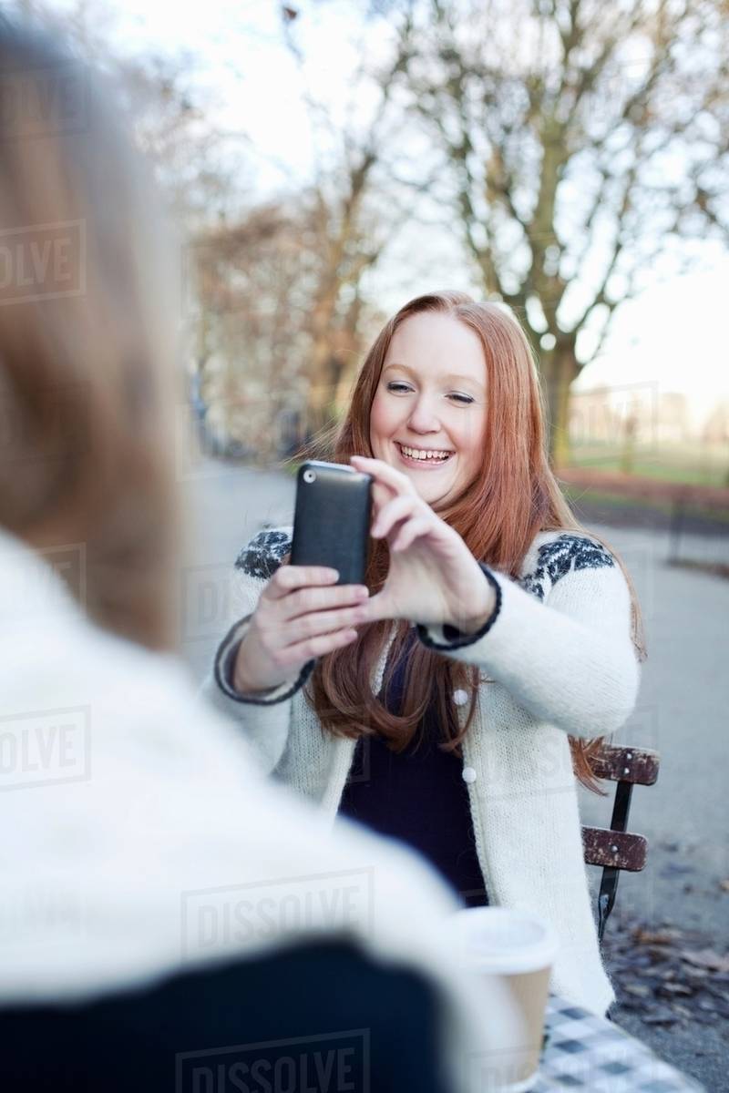 Woman taking cell phone picture - Stock Photo - Dissolve