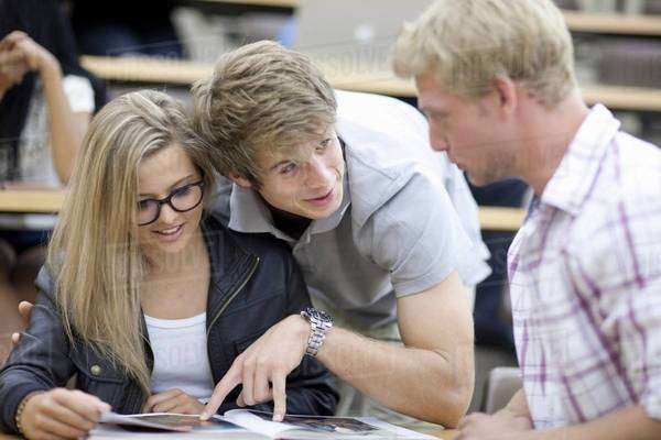 Three students talking - Royalty-free Stock Photo | Dissolve