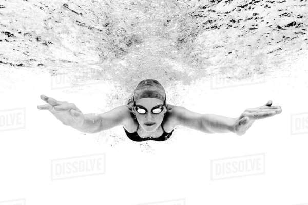 Young woman swimming underwater - Royalty-free Stock Photo | Dissolve
