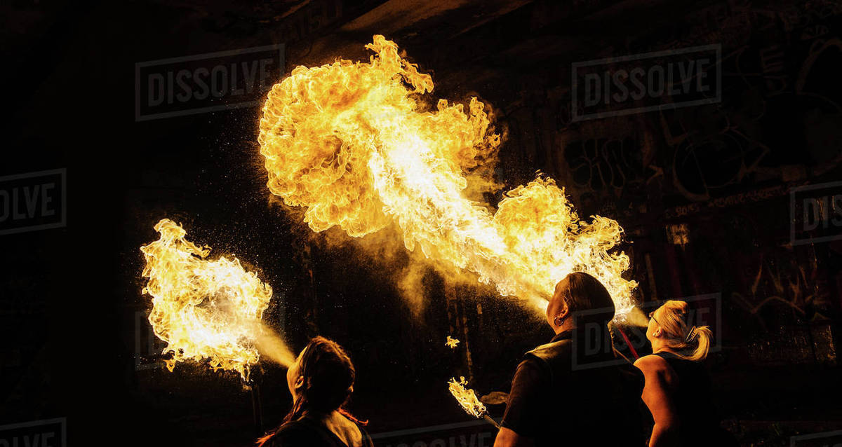Rear view of performers fire breathing - Royalty-free Stock Photo ...