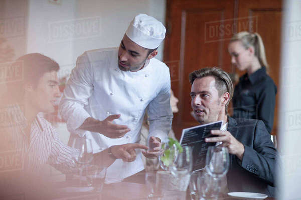Chef chatting with customers in restaurant - Royalty-free Stock Photo ...
